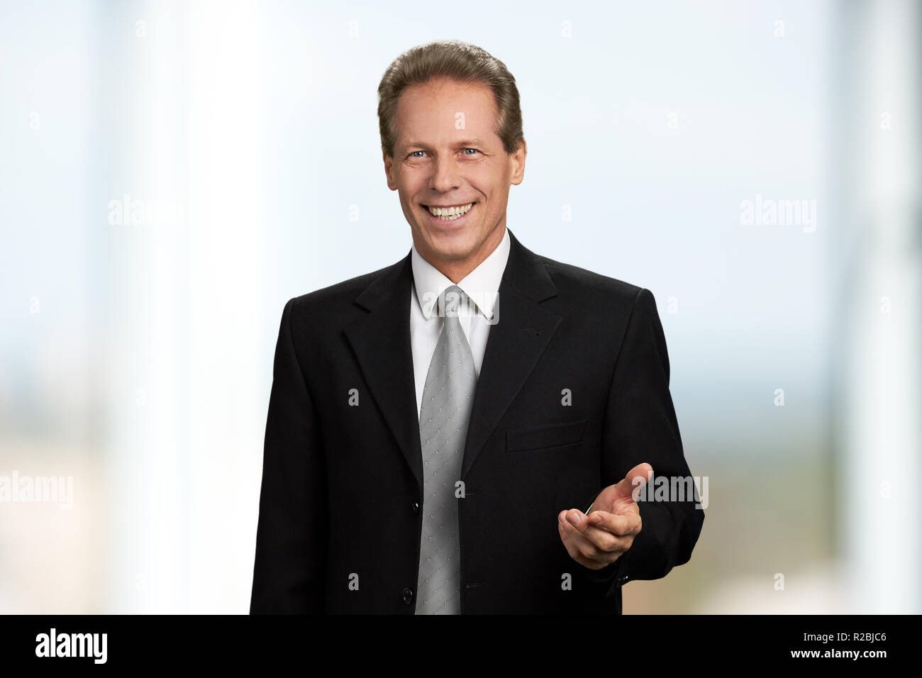 Happy smiling businessman gesturing with hand. Portrait of joyful ...
