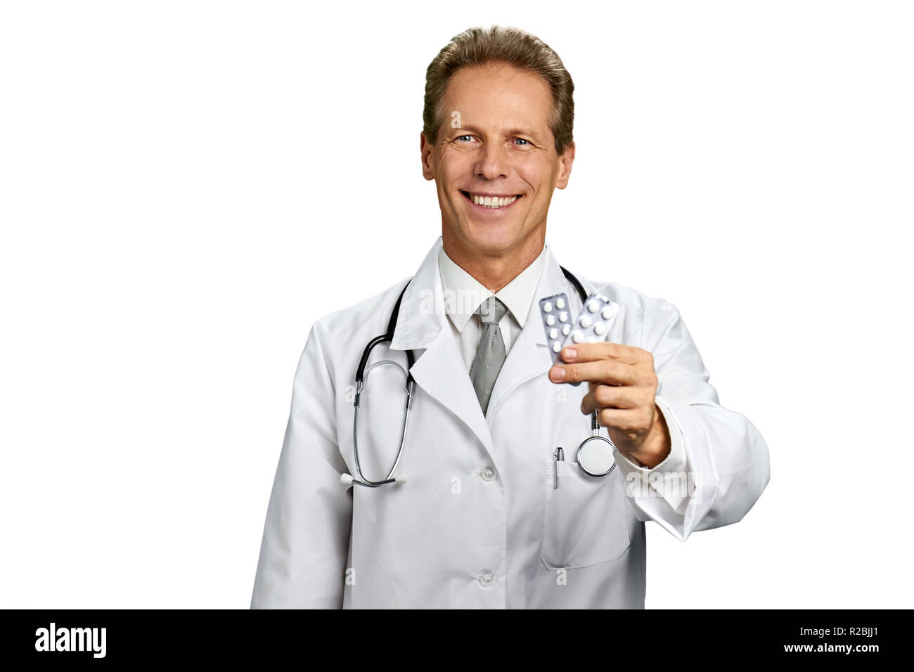 Portrait of happy medical doctor with pills. Smiling male doctor ...