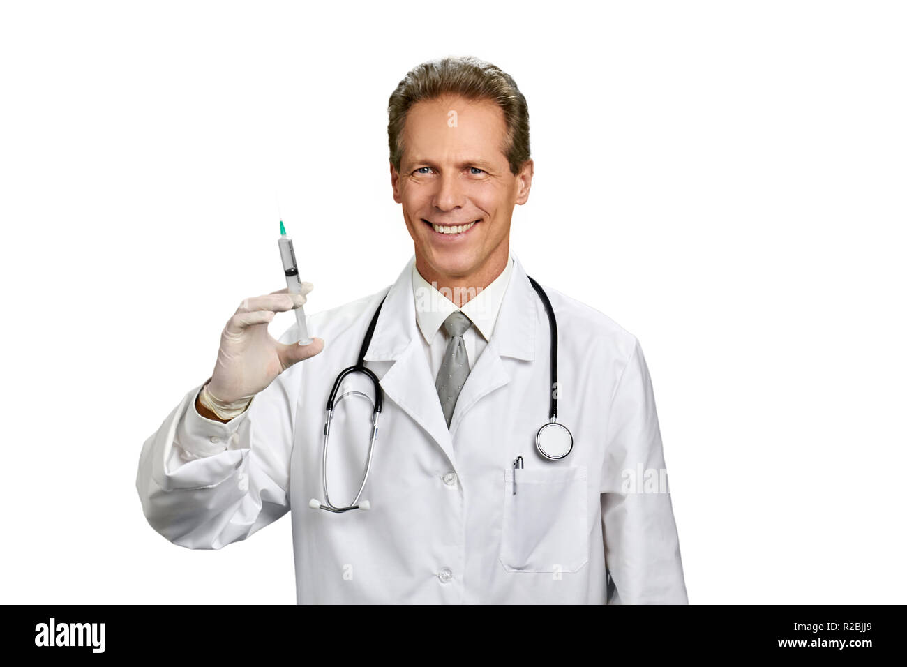 Portrait of cheerful male doctor with syringe. Caucasian smiling doctor ...