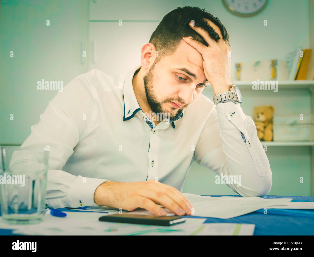 Distressed man having difficulties with paying utility bills and rent ...