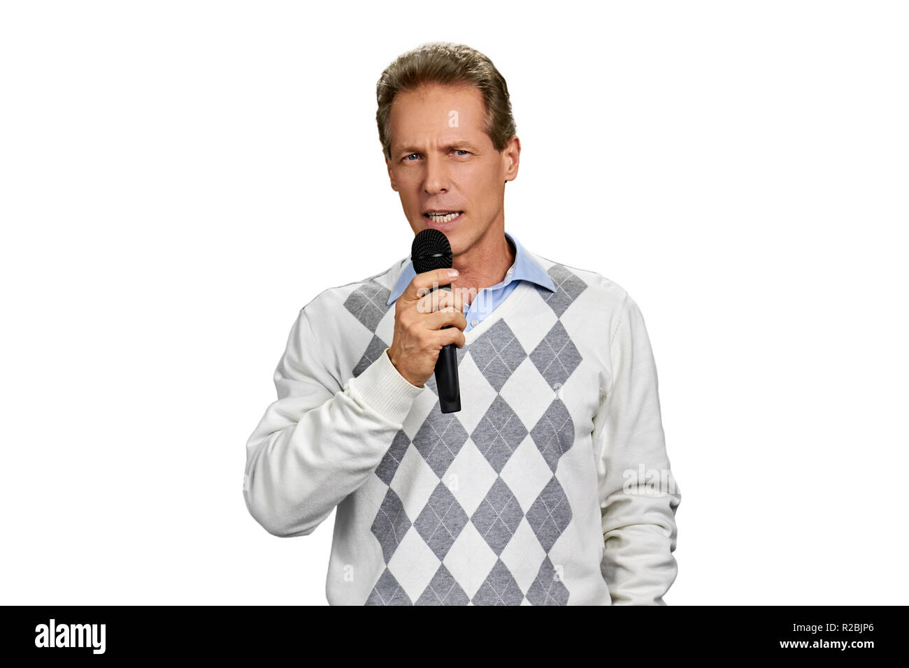 Portrait of man talking into microphone. Serious middle-aged man in ...