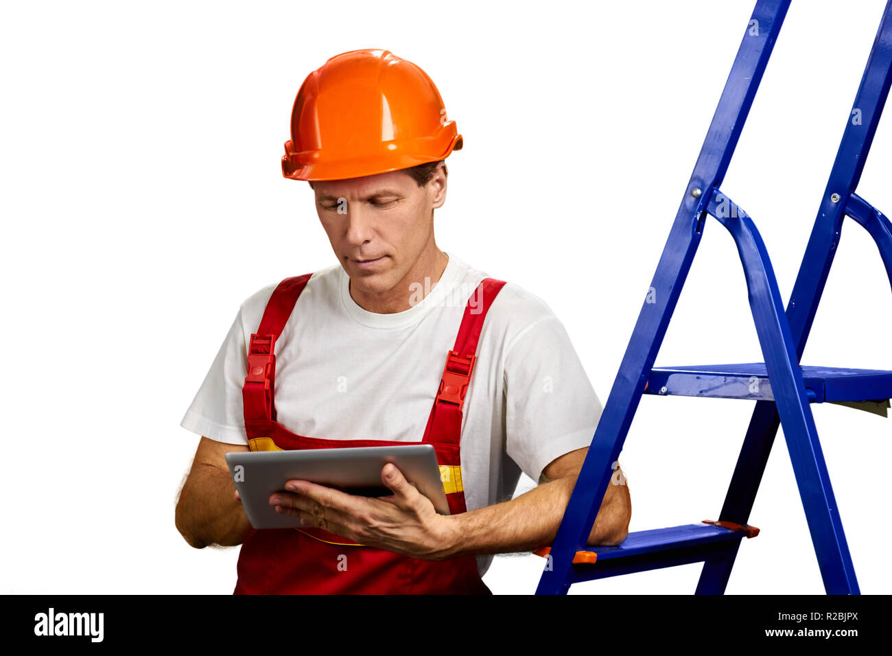 Portrait of architect working on pc tablet. Handsome engineer using ...