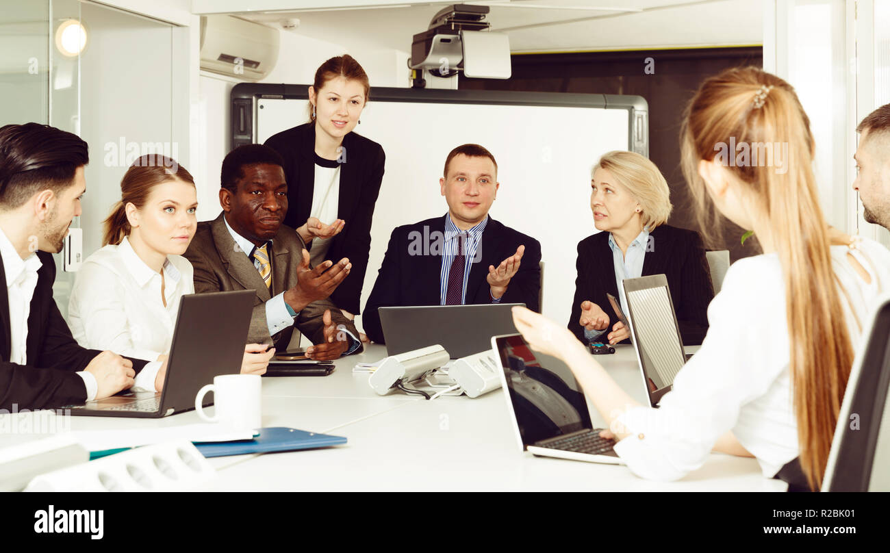 Multinational team of confident business people planning work at joint ...