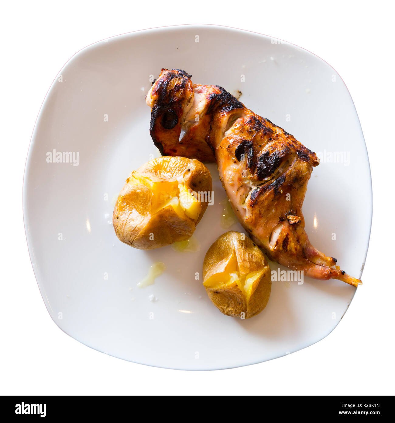 Image of baked in oven quarter of rabbit, served with pototoes at plate ...