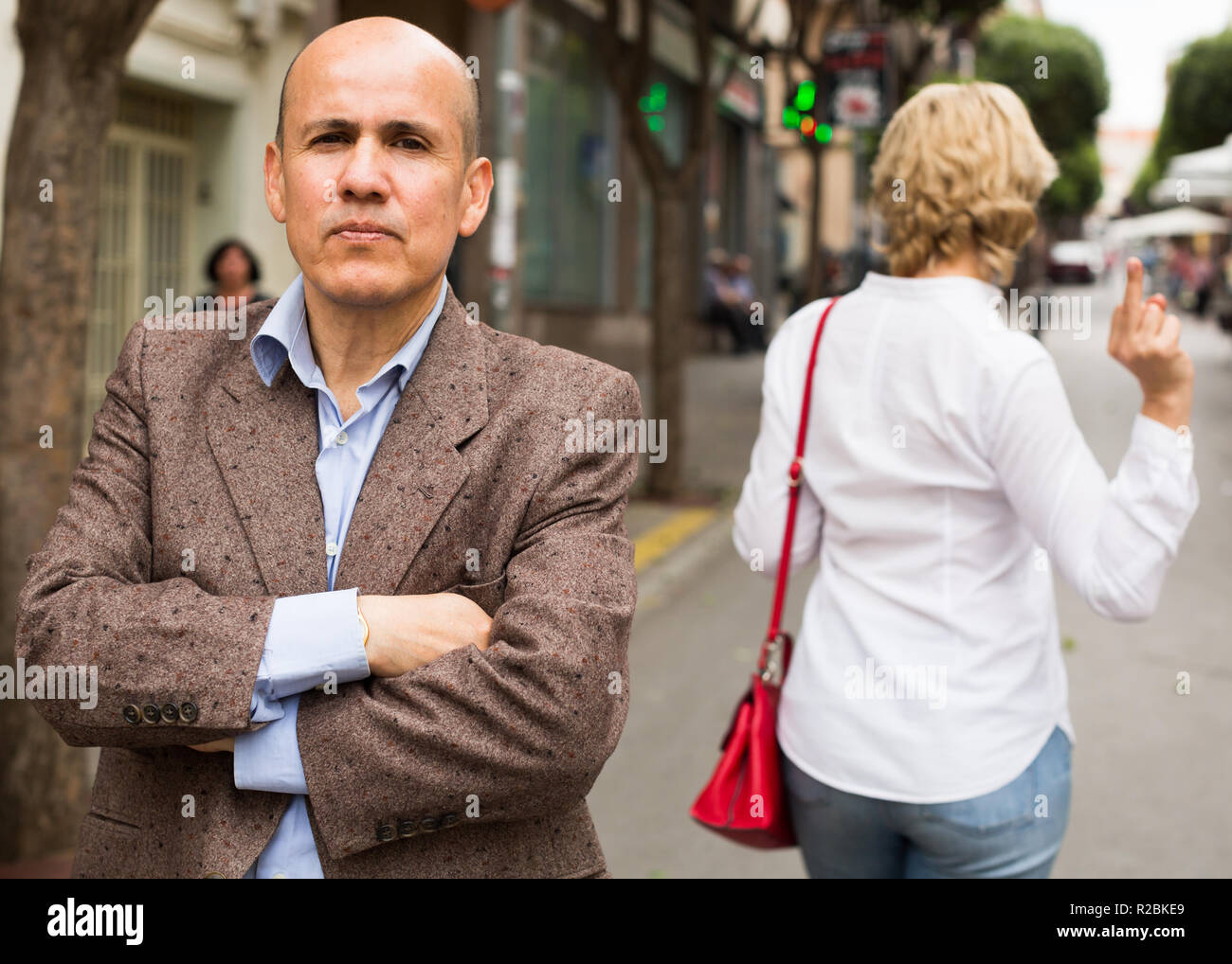 closeup of angry retiree man being sad with woman standing outdoors ...