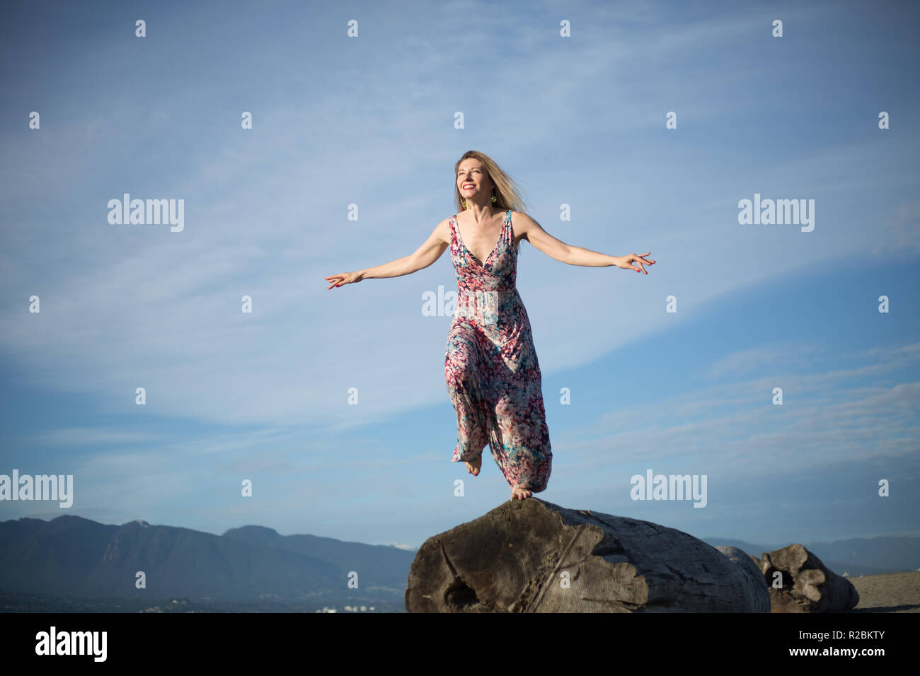 Young woman running background blue sky Stock Photo - Alamy