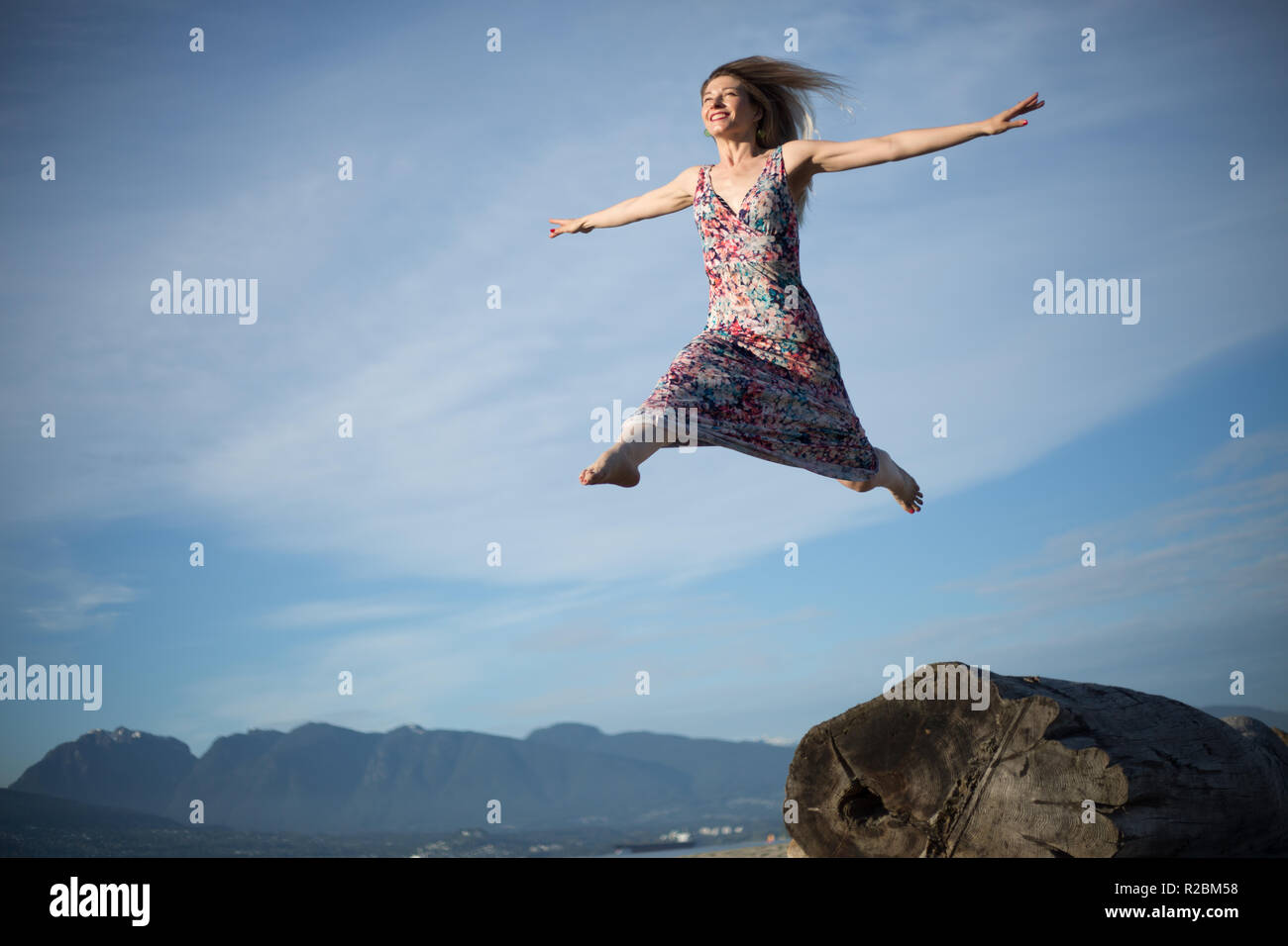 Young attractive female jumping sky Stock Photo - Alamy