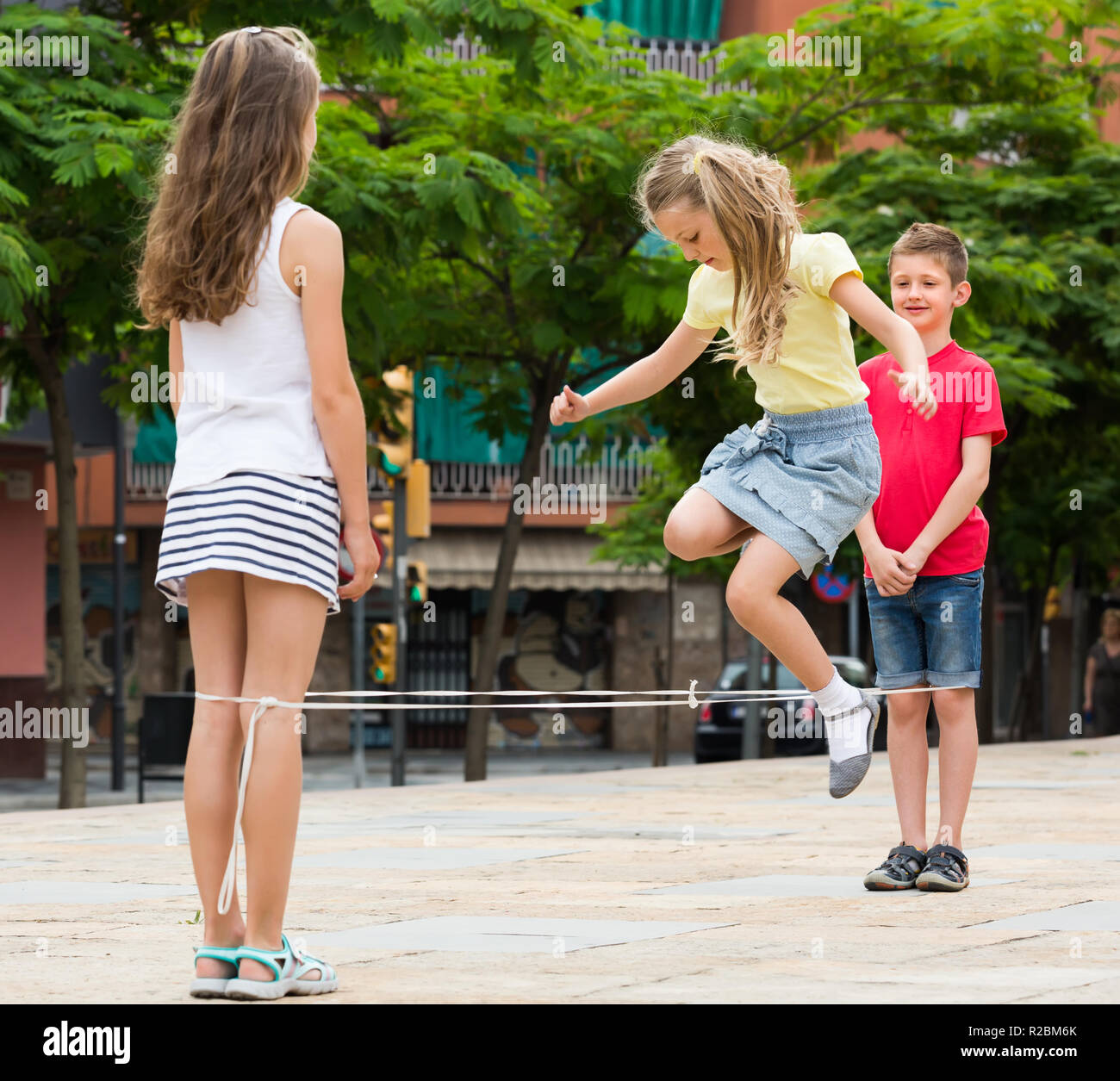 happy boy and girls in elementary school age playing with chinese ...