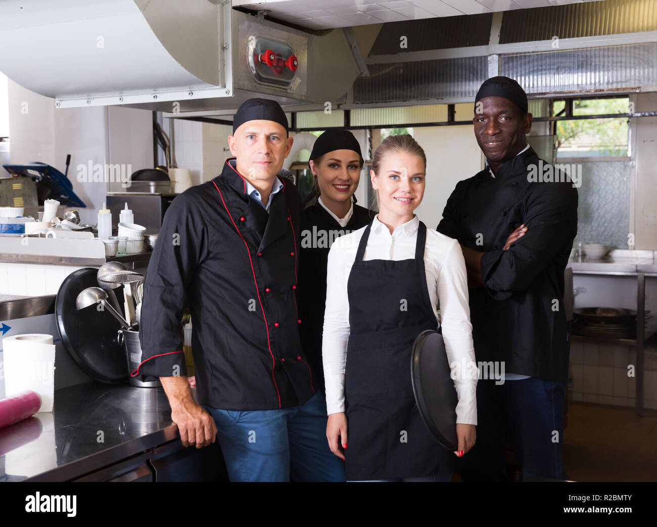 Successful multinational team of restaurant staff standing together in ...