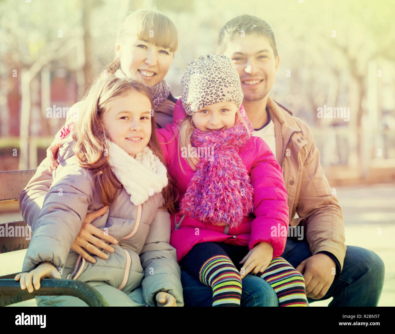 positive european family with two girls outdoors in sunny fall day ...