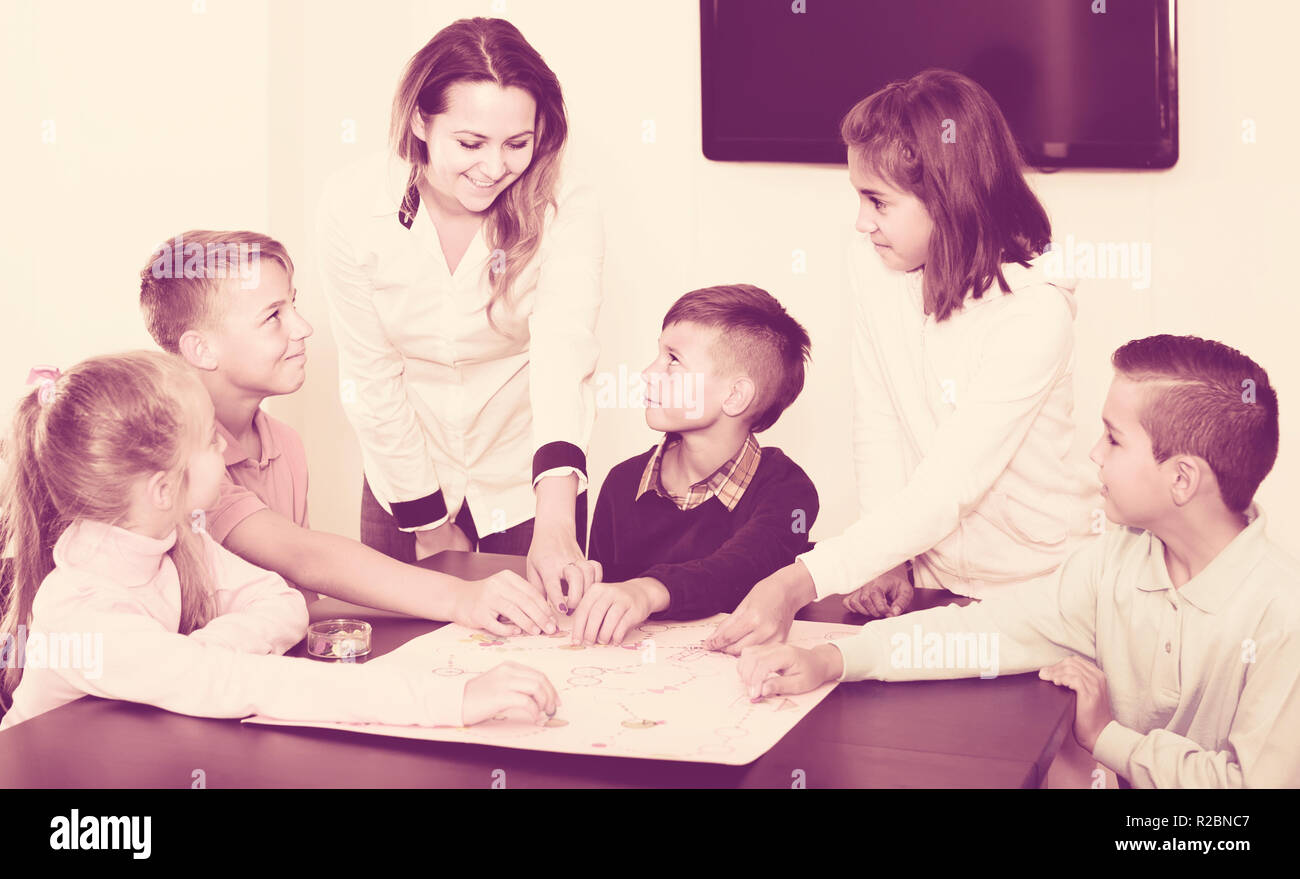 russian children making move on pre-marked surface of board game at ...