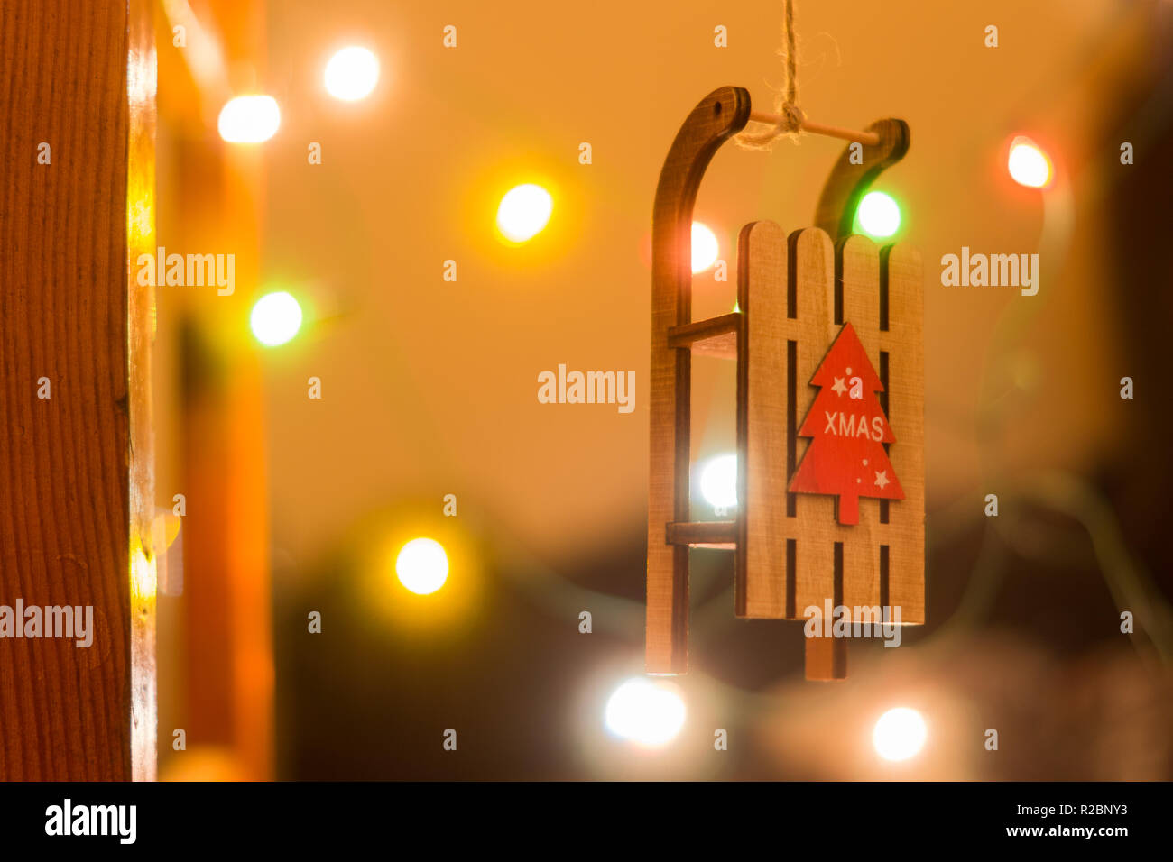 Christmas sled tree infront of colorful lights bokeh Stock Photo - Alamy
