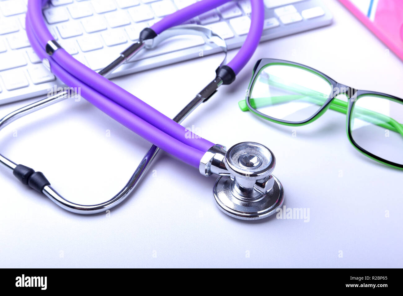 Medical record concept with stethoscope over pile of folders. Keyboard ...