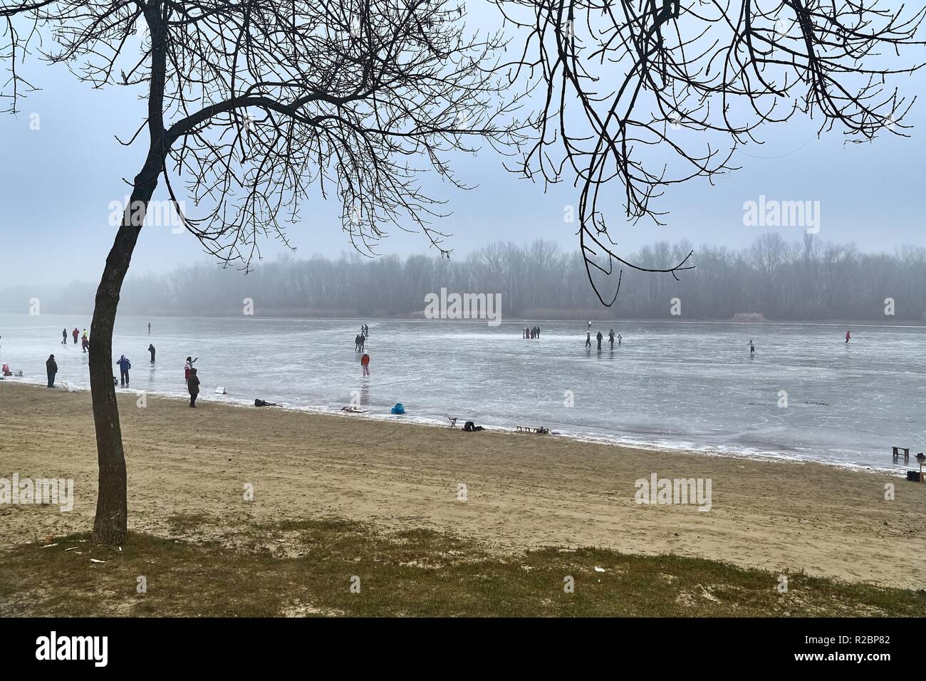 Skating on frozen lake Stock Photo - Alamy