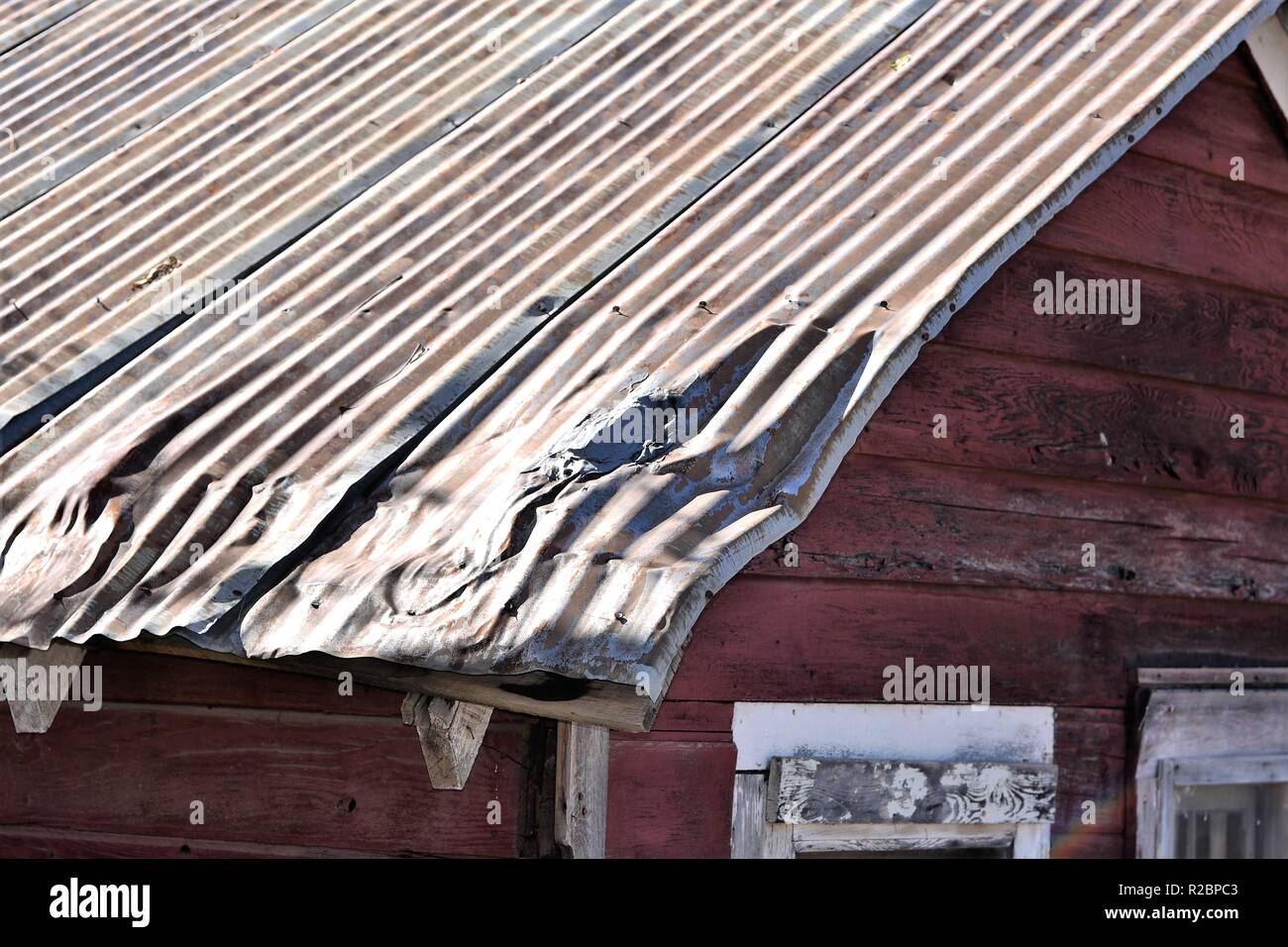 Damage on old metal roof Stock Photo - Alamy