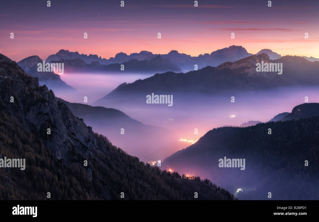 Mountains in fog at beautiful night in autumn in Dolomites, Italy ...
