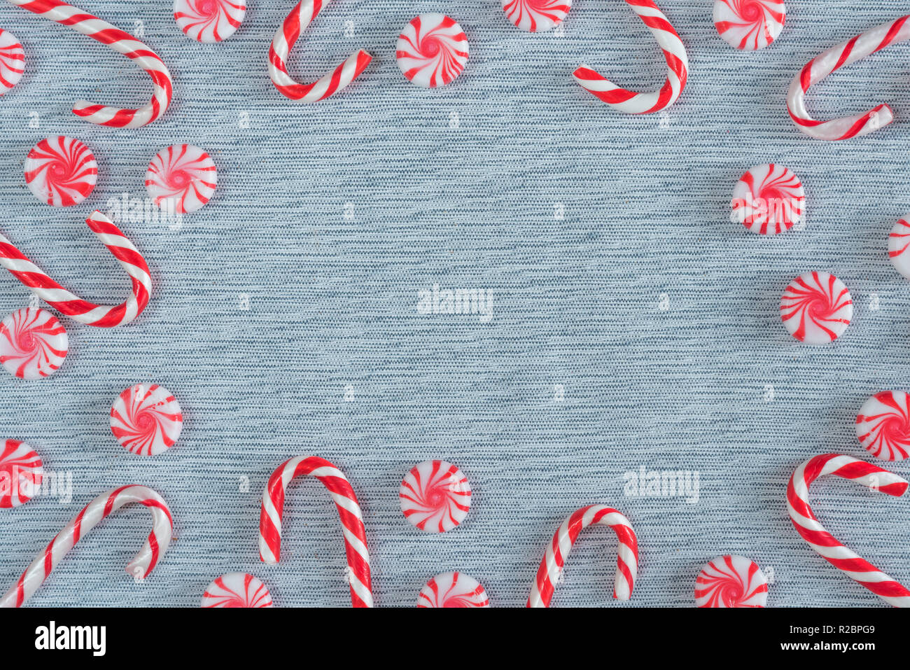 Flat lay frame of Christmas candy canes and peppermint swirl candies ...