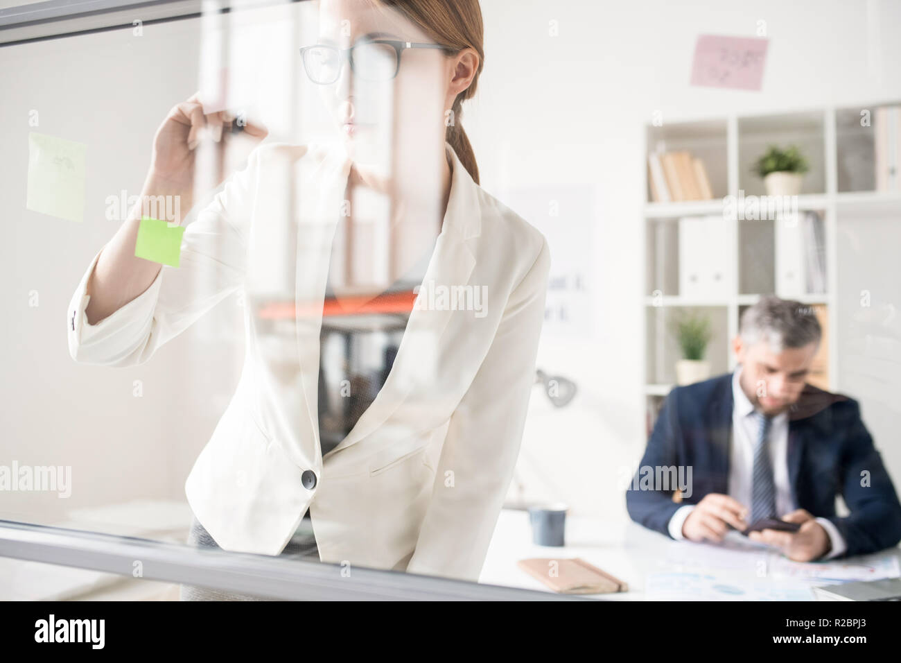 Concentrated lady making notes while working on marketing projec Stock ...