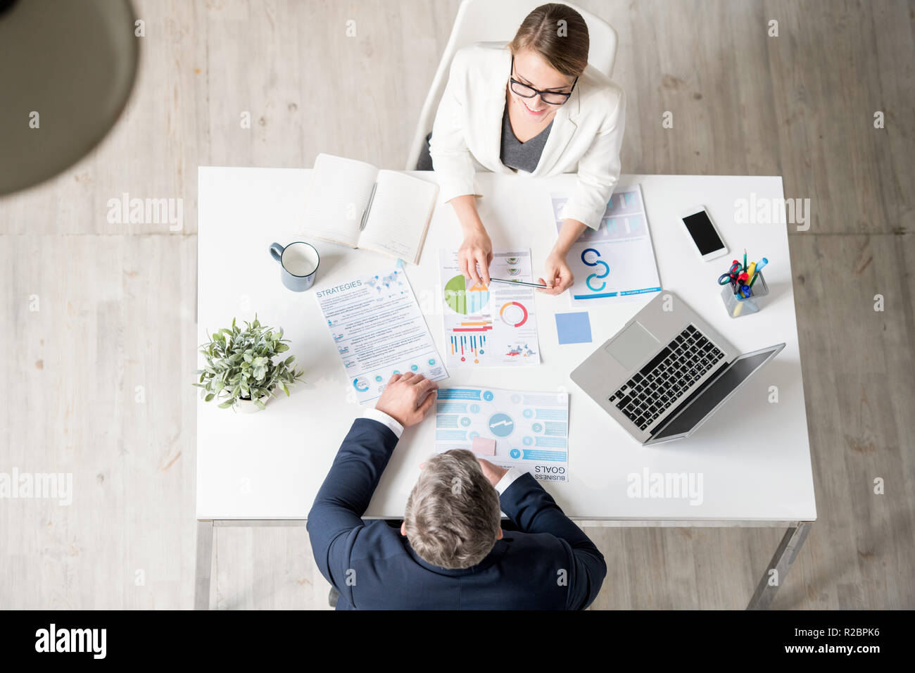 Analytical expert explaining statistics to businessman Stock Photo - Alamy