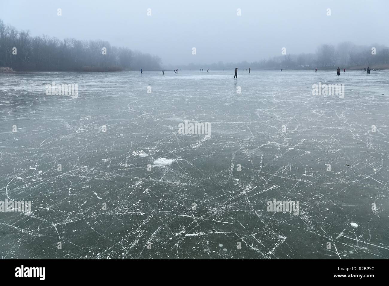 Skating on frozen lake Stock Photo - Alamy