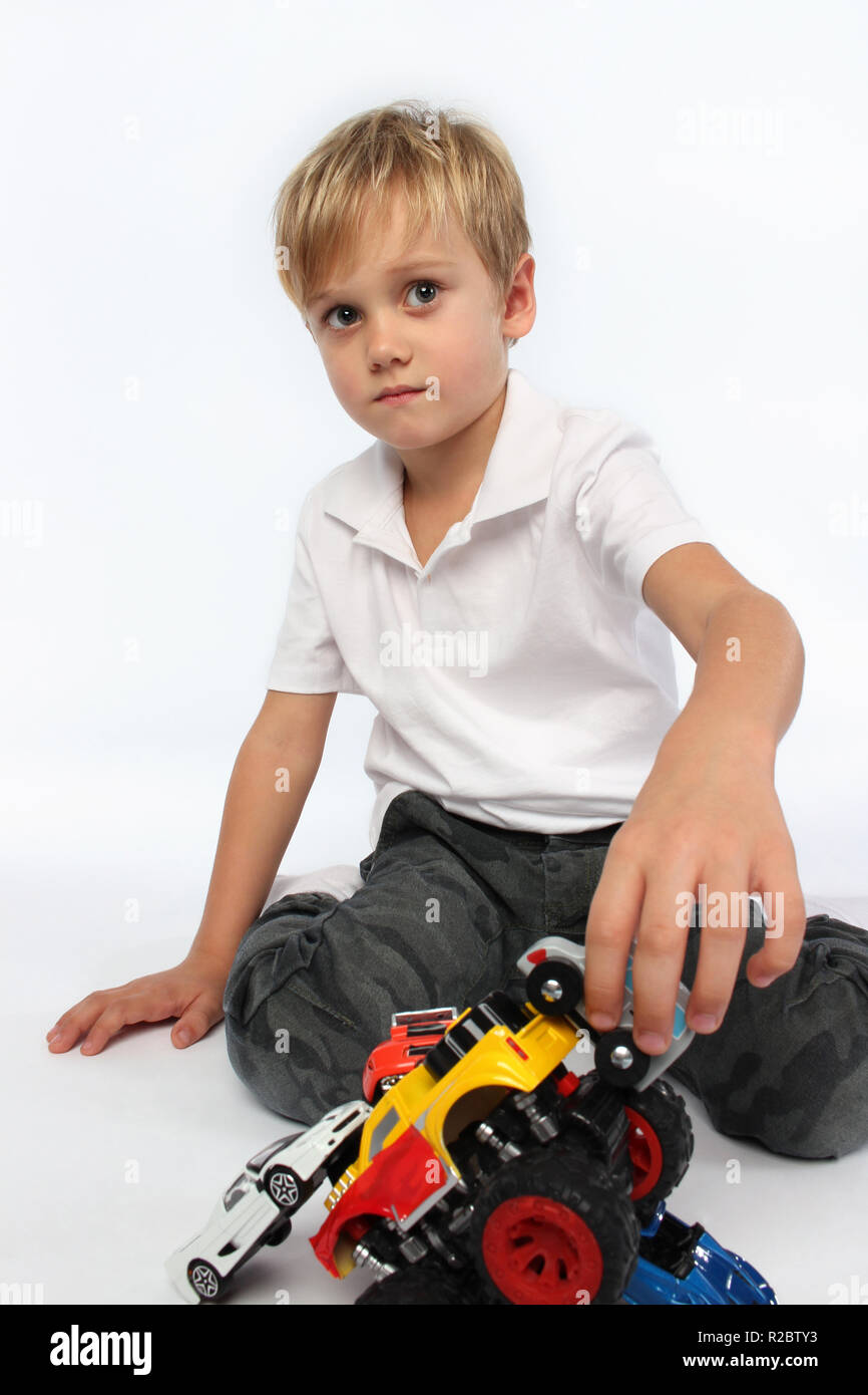 Small handsome boy playing with toys Stock Photo - Alamy