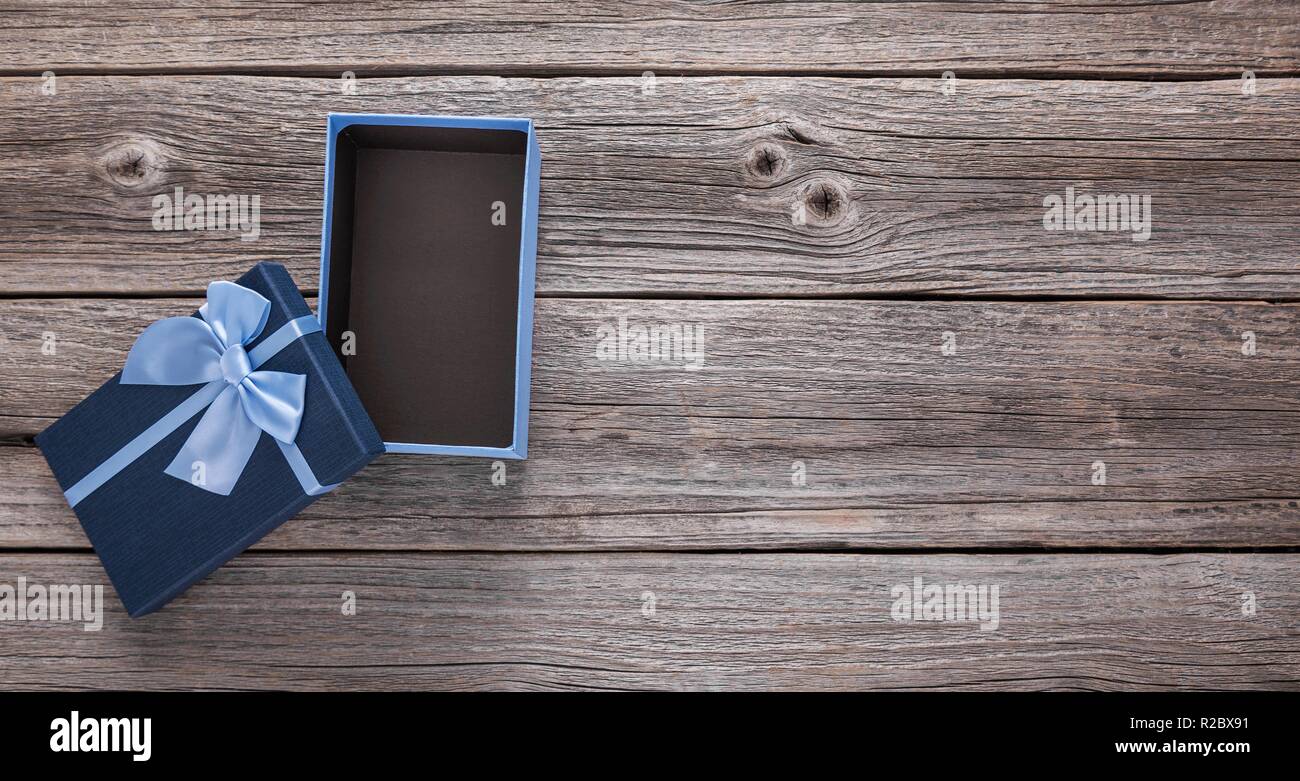 Open gift box on the background of wooden boards Stock Photo - Alamy
