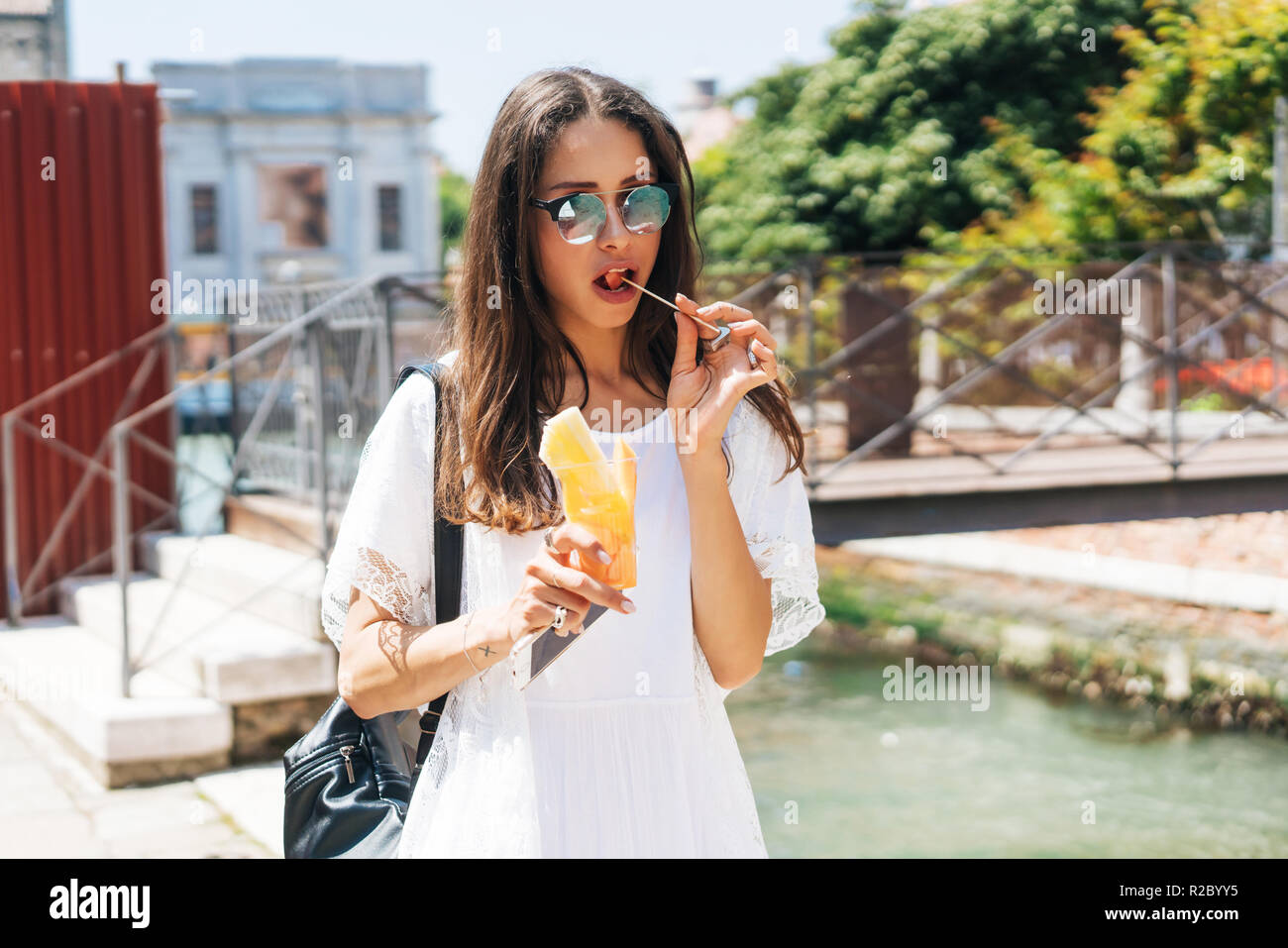 Beautiful young woman eating healthy food on travel vacation Stock ...