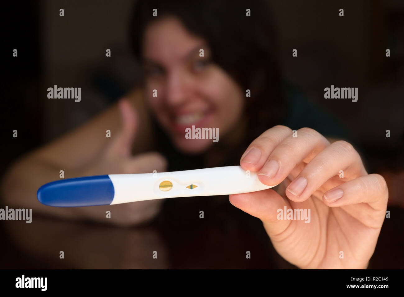 Happy Mom Looking at Home Pregnancy Test Results Stock Photo - Alamy