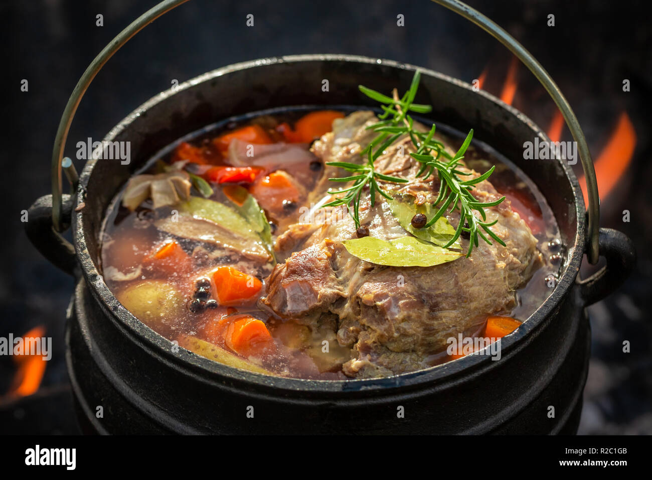Hot and yummy hunter's stew on campfire Stock Photo - Alamy