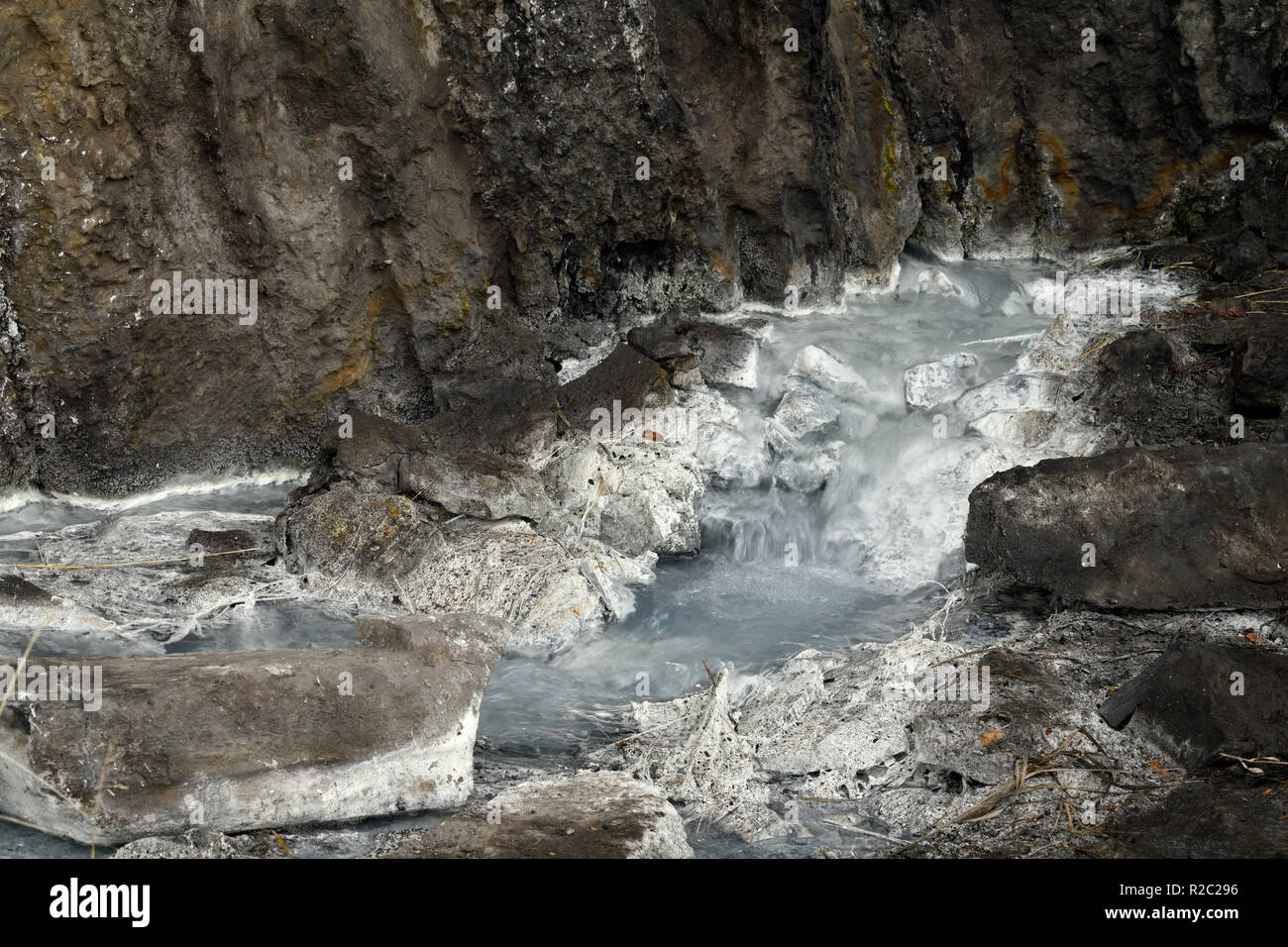 A close up image of a sulpher spring and the opening in the mountain ...