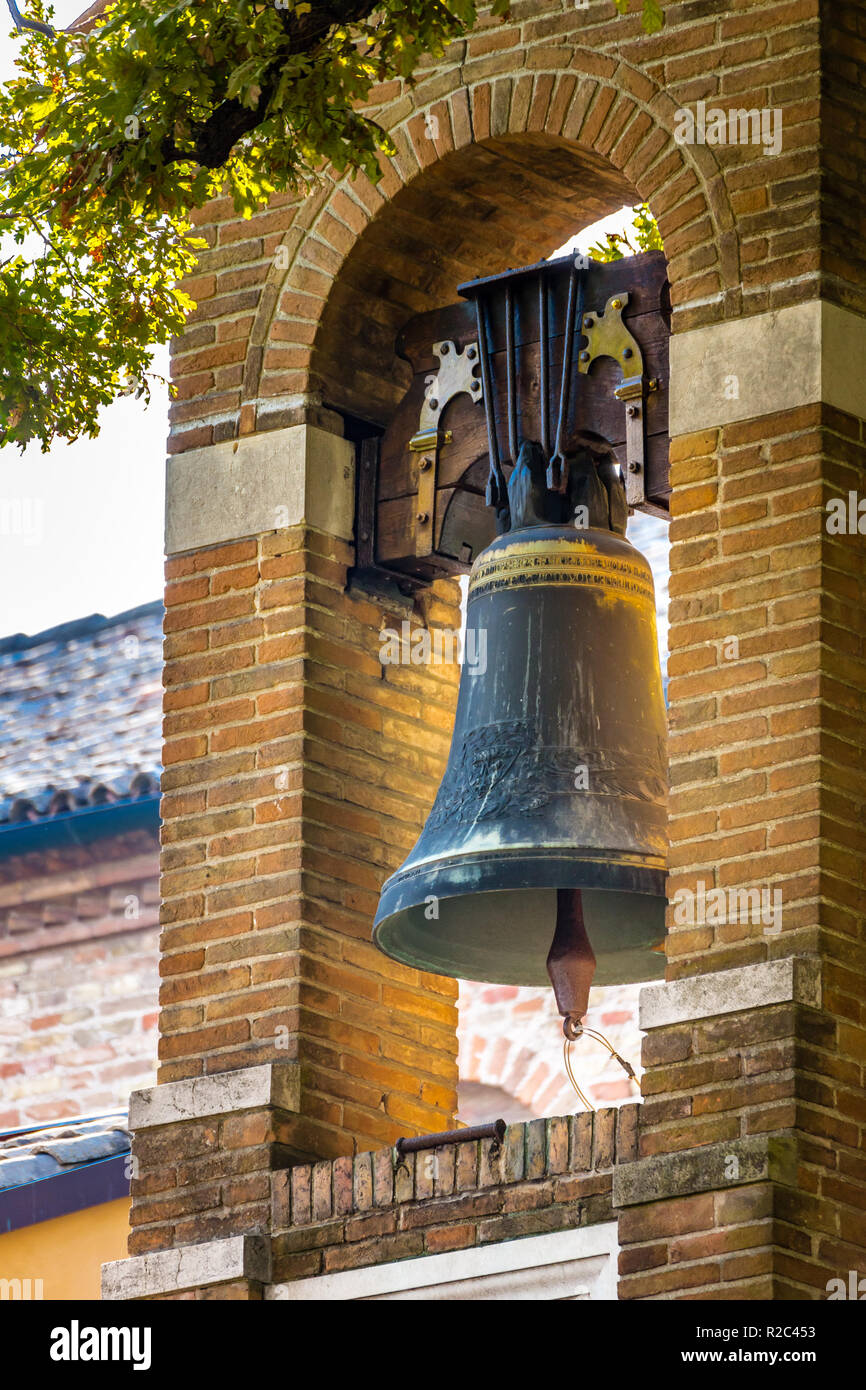 ancient bronze bell in brick wall structure Stock Photo - Alamy