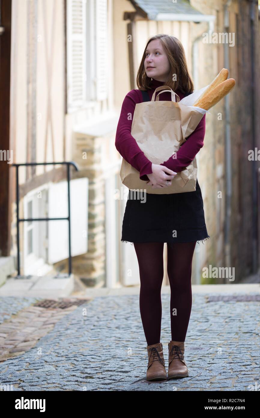 French girl with baguettes on the street side of the city Stock Photo ...
