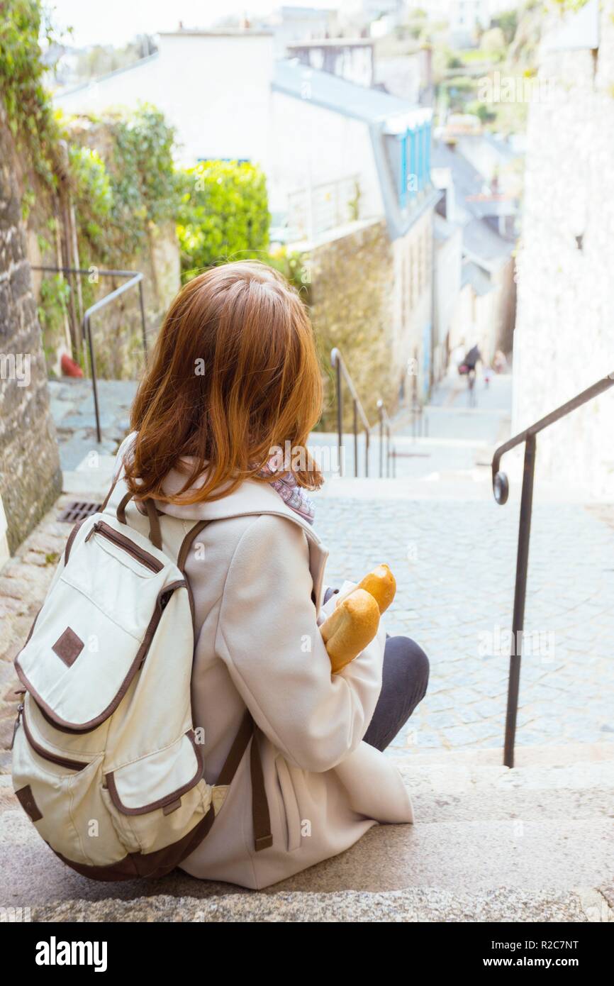 French girl with baguettes on the street side of the city Stock Photo ...