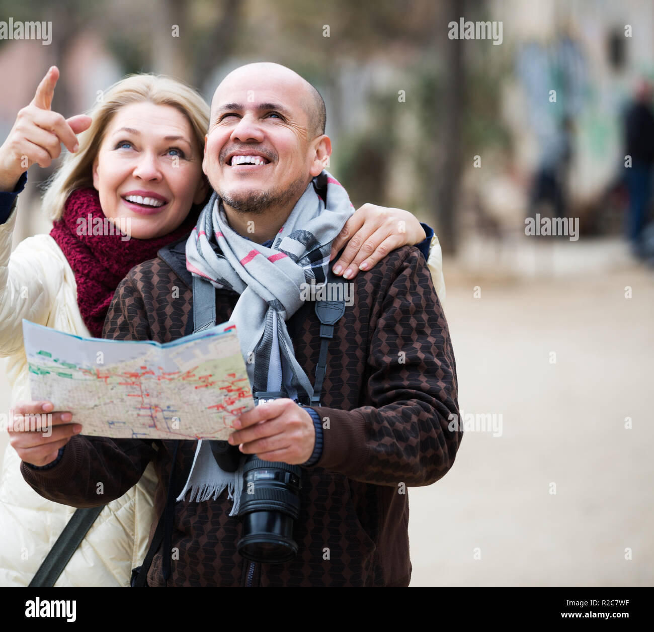 Portrait of happy mature spouses with paper map outdoors Stock Photo ...
