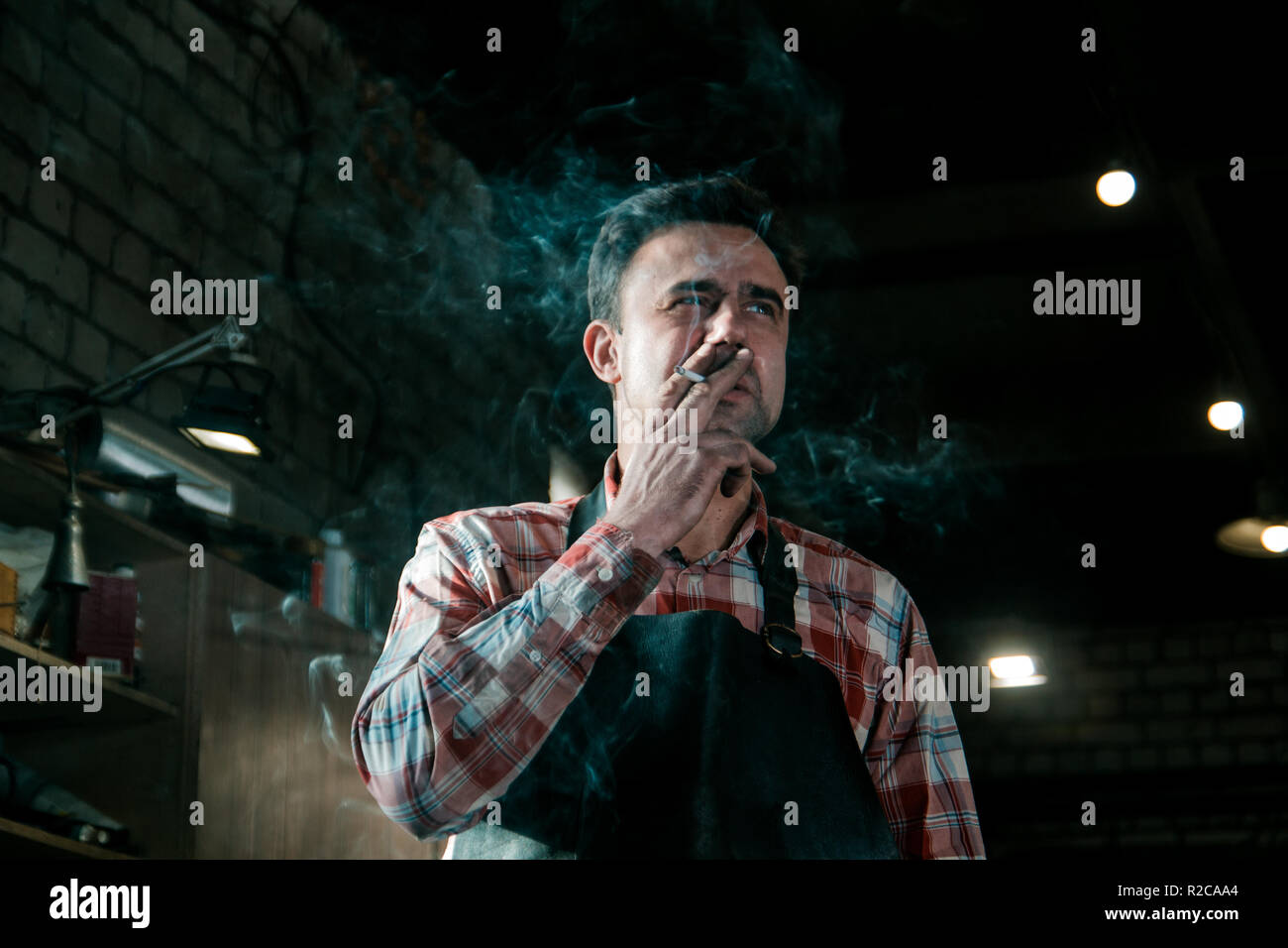 Man smokes cigarette in slow hi-res stock photography and images - Alamy