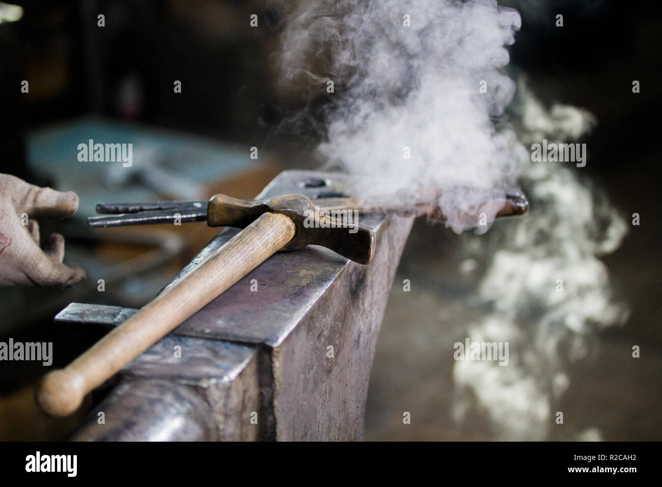 steam comes from the different tools lies on anvil at forge Stock Photo ...