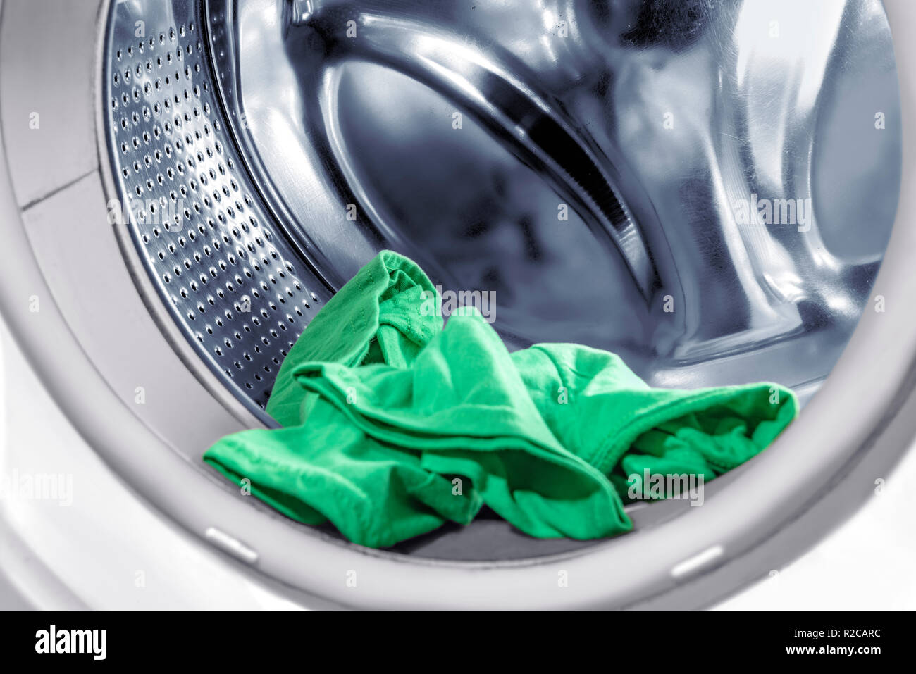 Clothes inside washing machine tube over white background Stock Photo ...