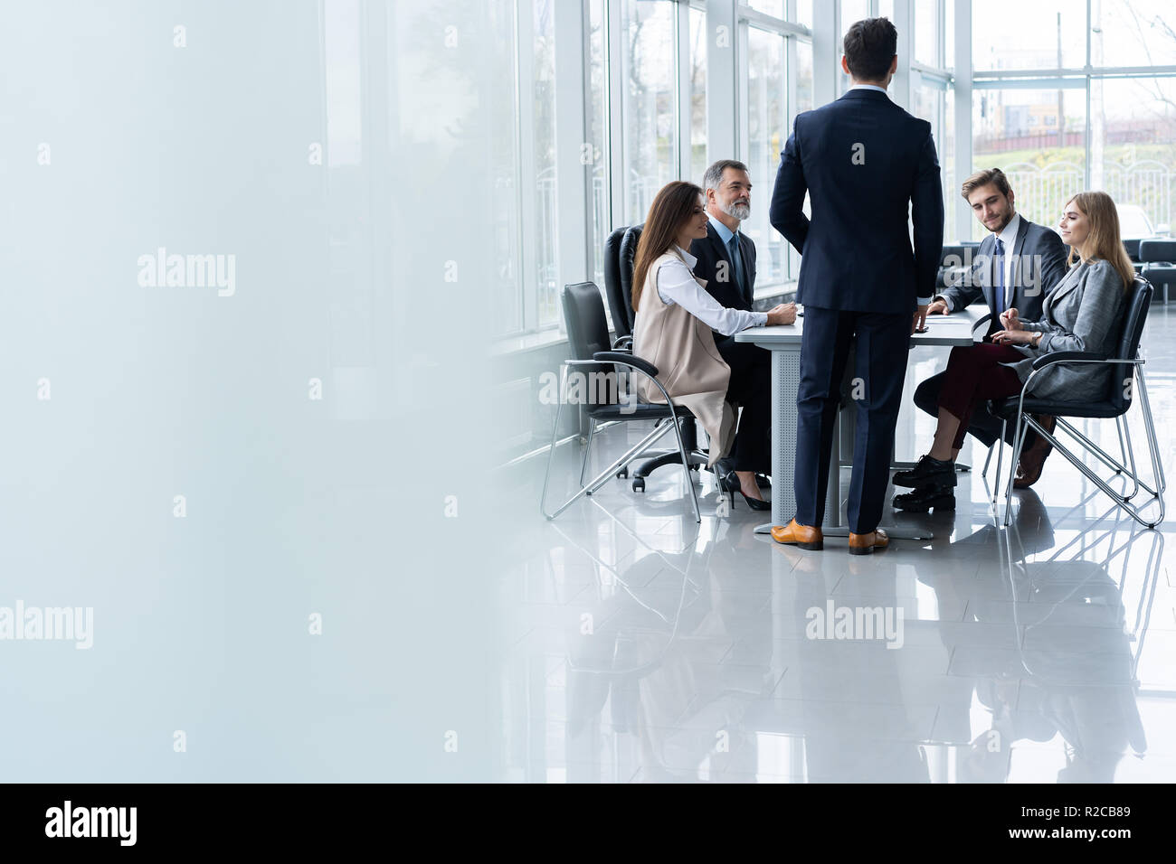 Successful team leader and business owner leading informal in-house ...