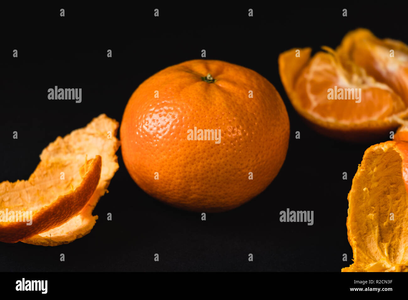 Still life with clementine and clementine skin on a Black background ...
