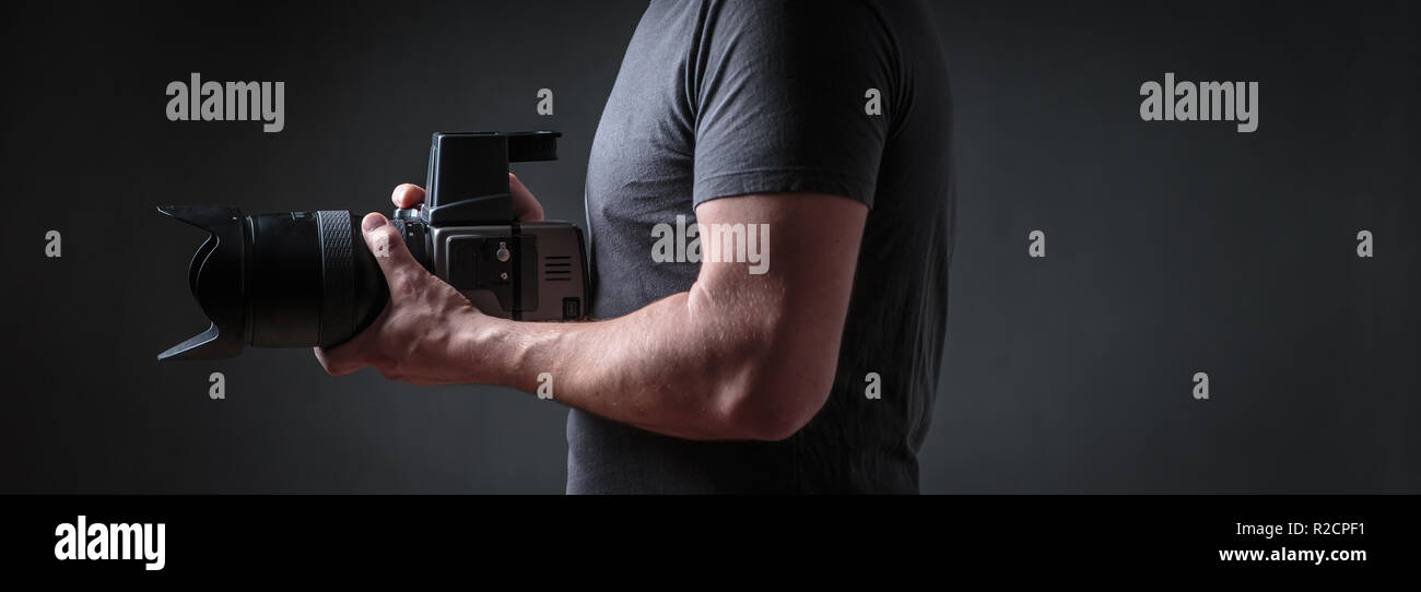 Photographer with a medium format camera in his studio Stock Photo - Alamy