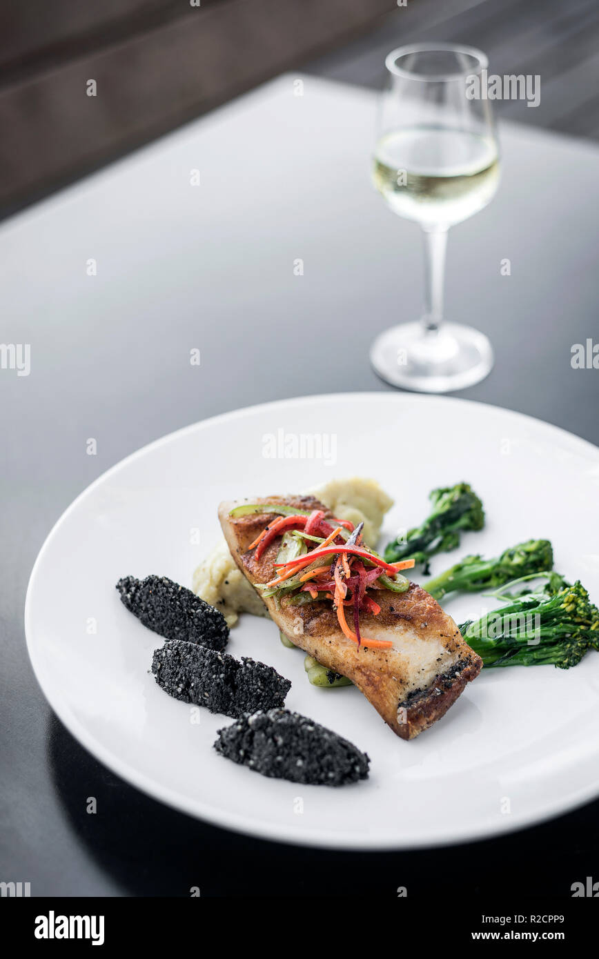 red snapper fish fillet with vegetables and black rice with black ...