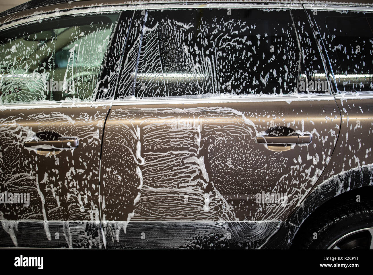 Car in a carwash covered with shampoo Stock Photo - Alamy