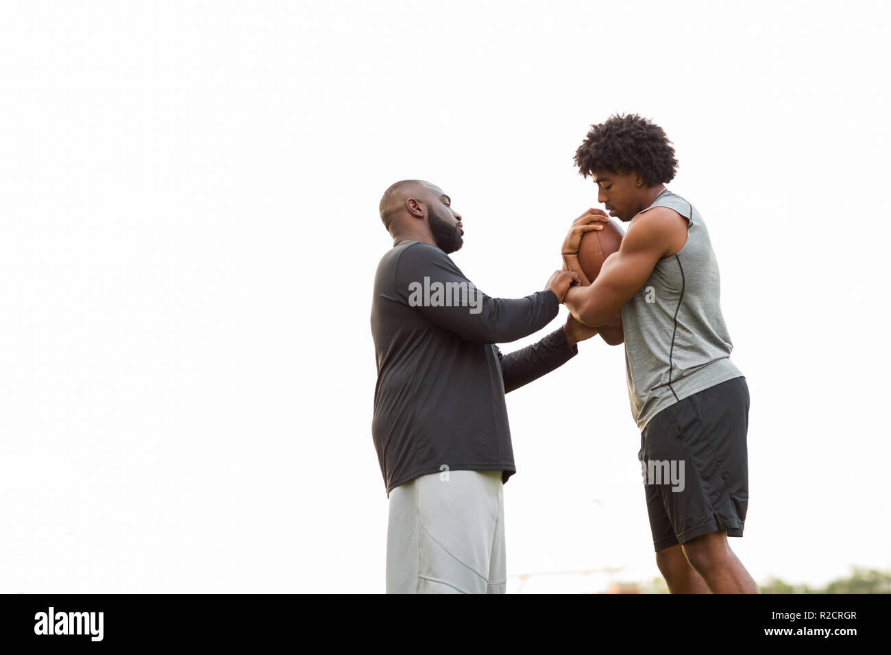 American Football coach training a young athlete Stock Photo - Alamy