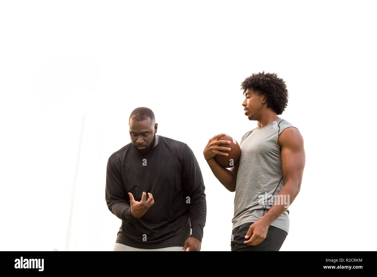 American Football coach training a young athlete Stock Photo - Alamy