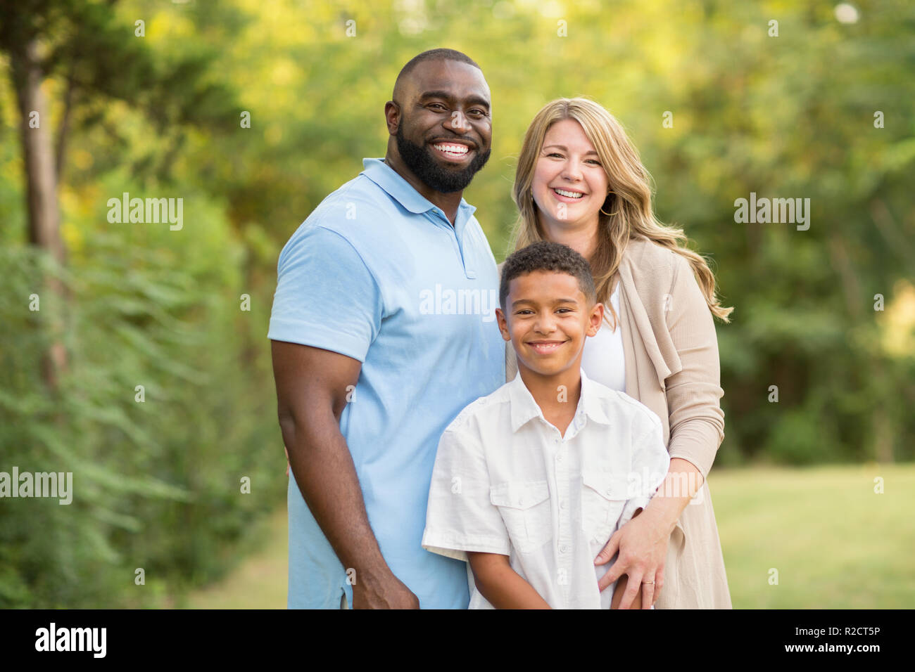 Portrait of a multi ethnic family laughing Stock Photo - Alamy