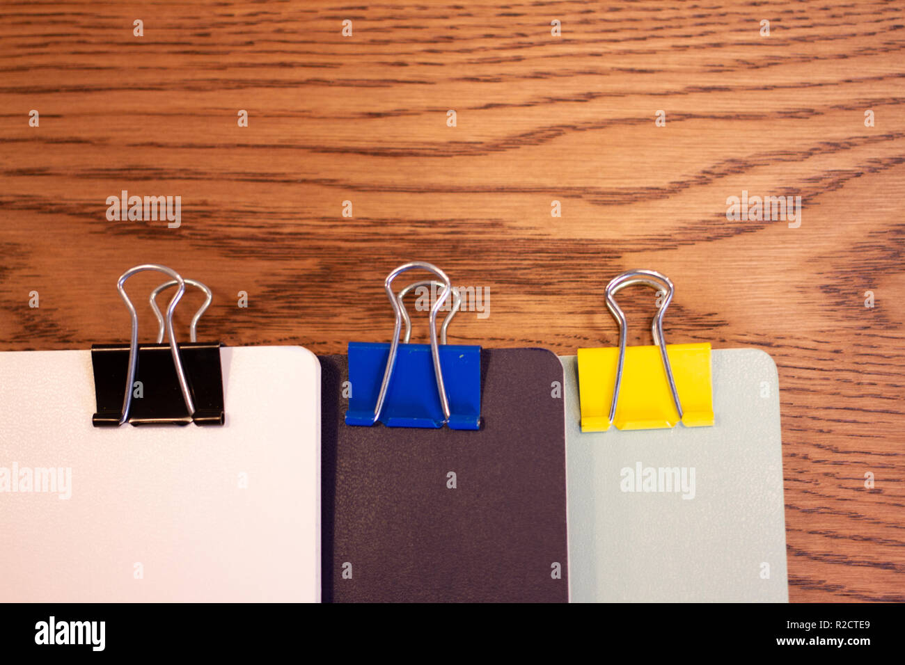 Colorful Notebooks with Large Paper Clips Stock Photo - Alamy