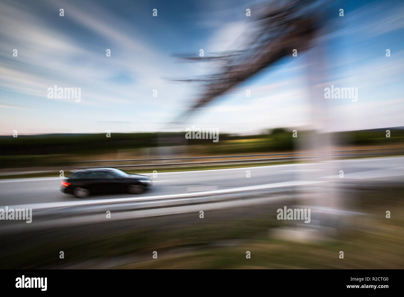 Cars going fast on a highway (motion blurred image; color toned image ...