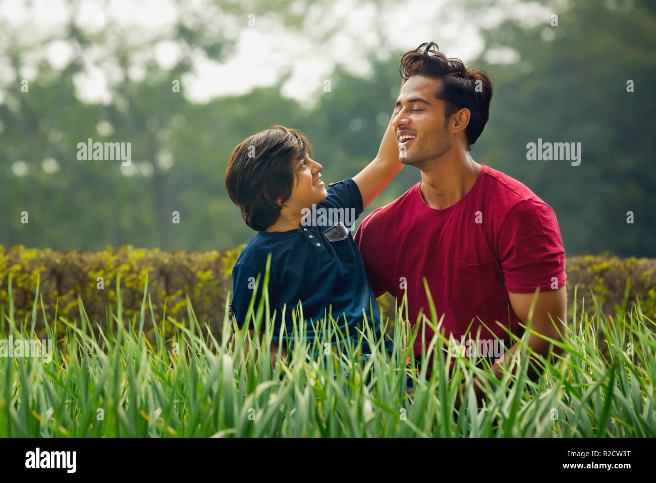 Child touching grass hi-res stock photography and images - Alamy