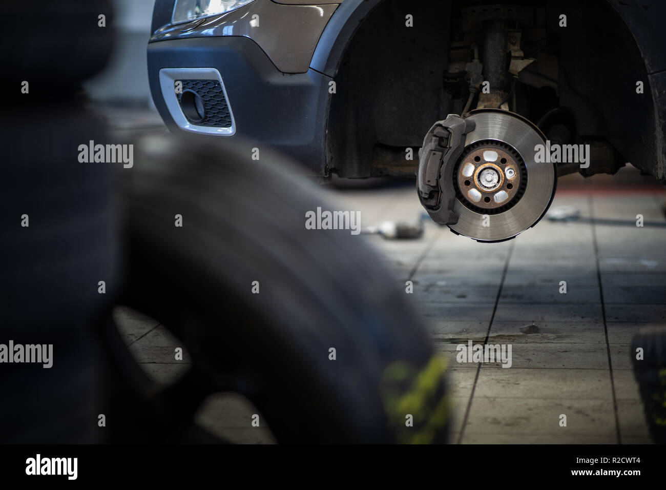 Mechanic changing a wheel of a modern car (color toned image Stock ...