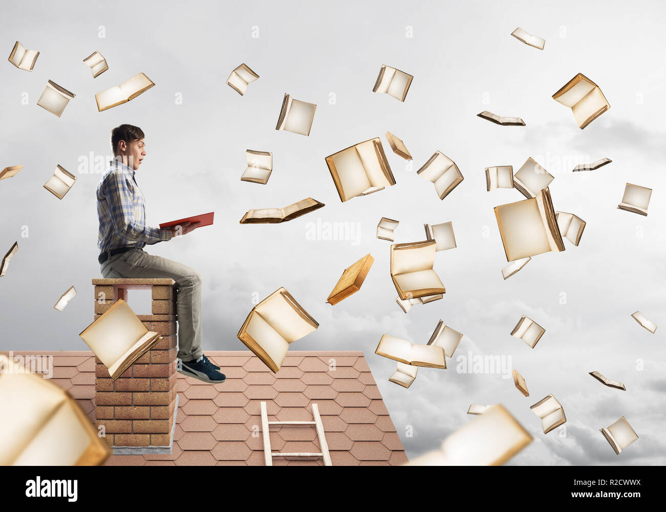 Man reading book and many of them flying in air Stock Photo - Alamy